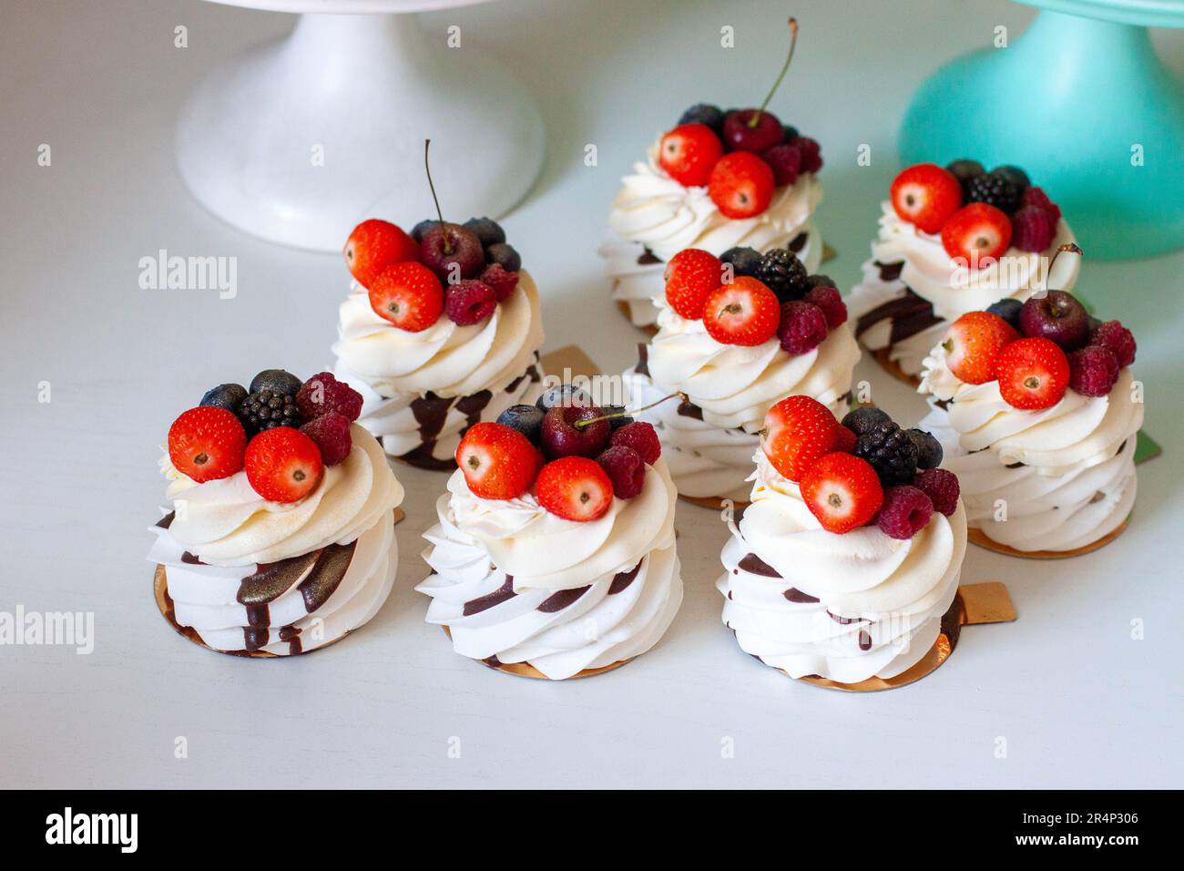 Delicious mini Pavlova meringue cakes decorated with fresh raspberry ...