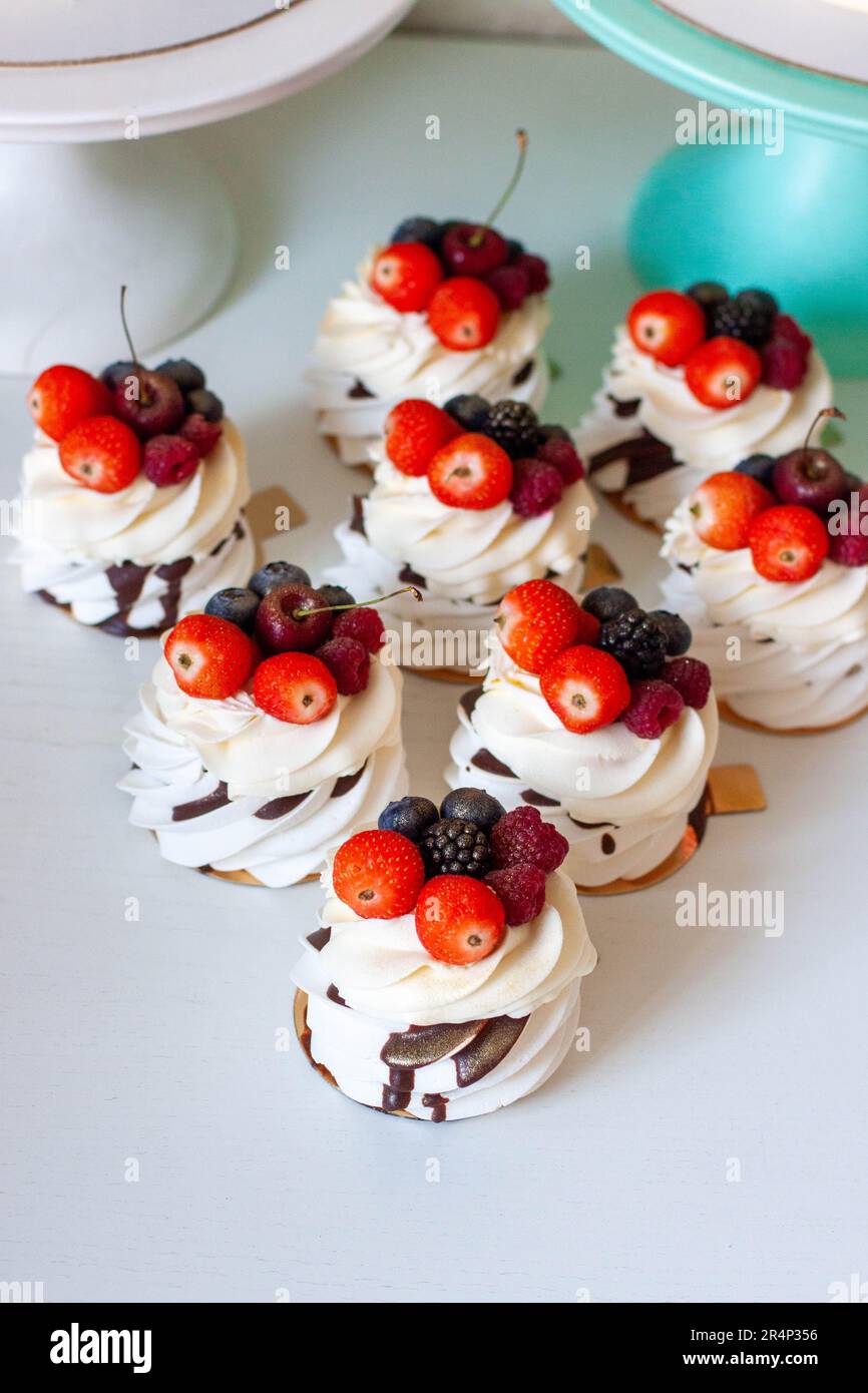 Delicious mini Pavlova meringue cakes decorated with fresh raspberry ...