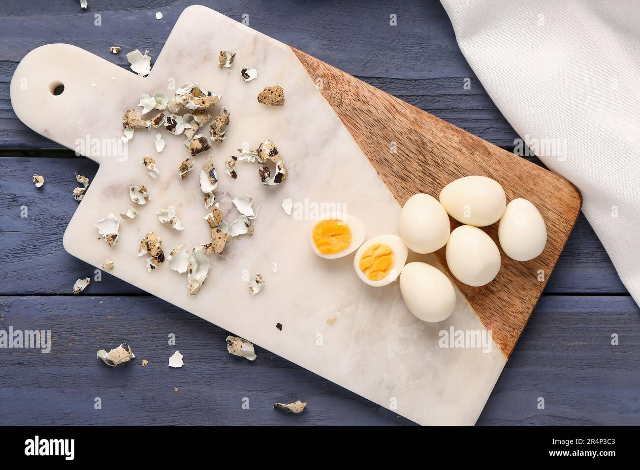 Board of boiled quail eggs and shells on blue wooden background Stock ...