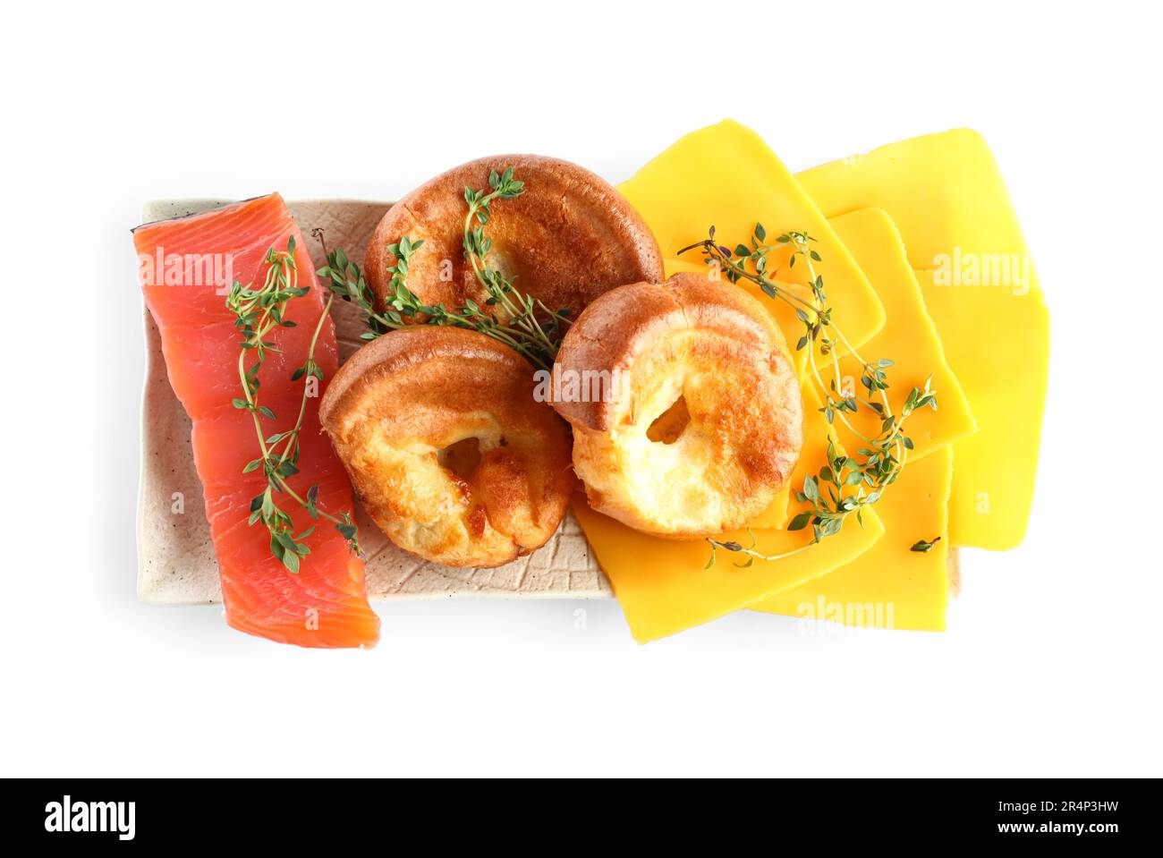 Plate with tasty Yorkshire pudding, fish and cheese isolated on white ...