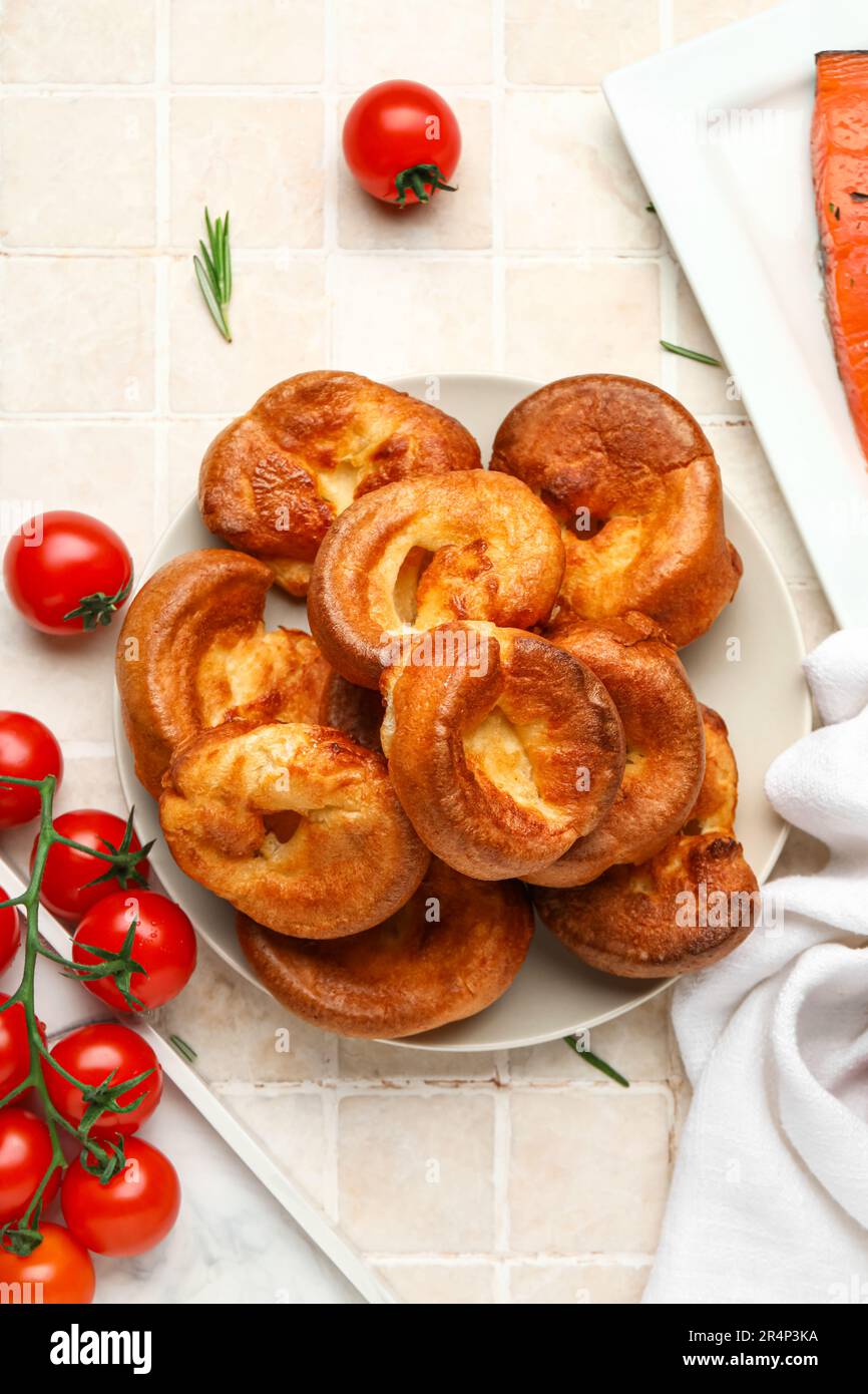 Plate with tasty Yorkshire pudding on light tile background Stock Photo ...