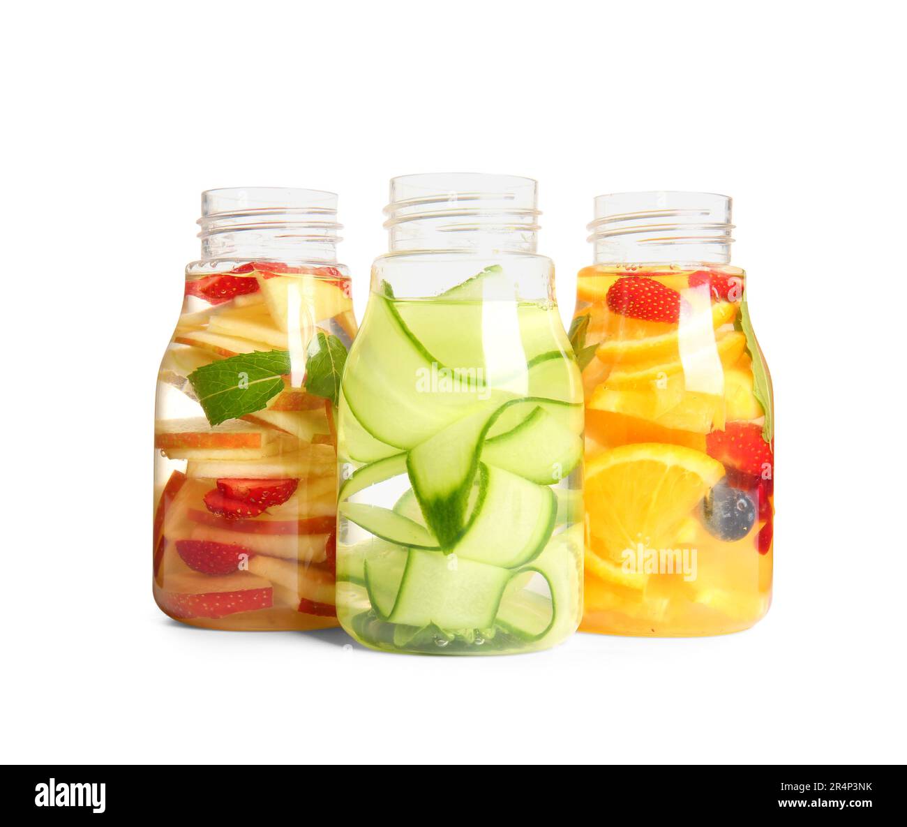 Bottles of infused water with different sliced fruits on white ...