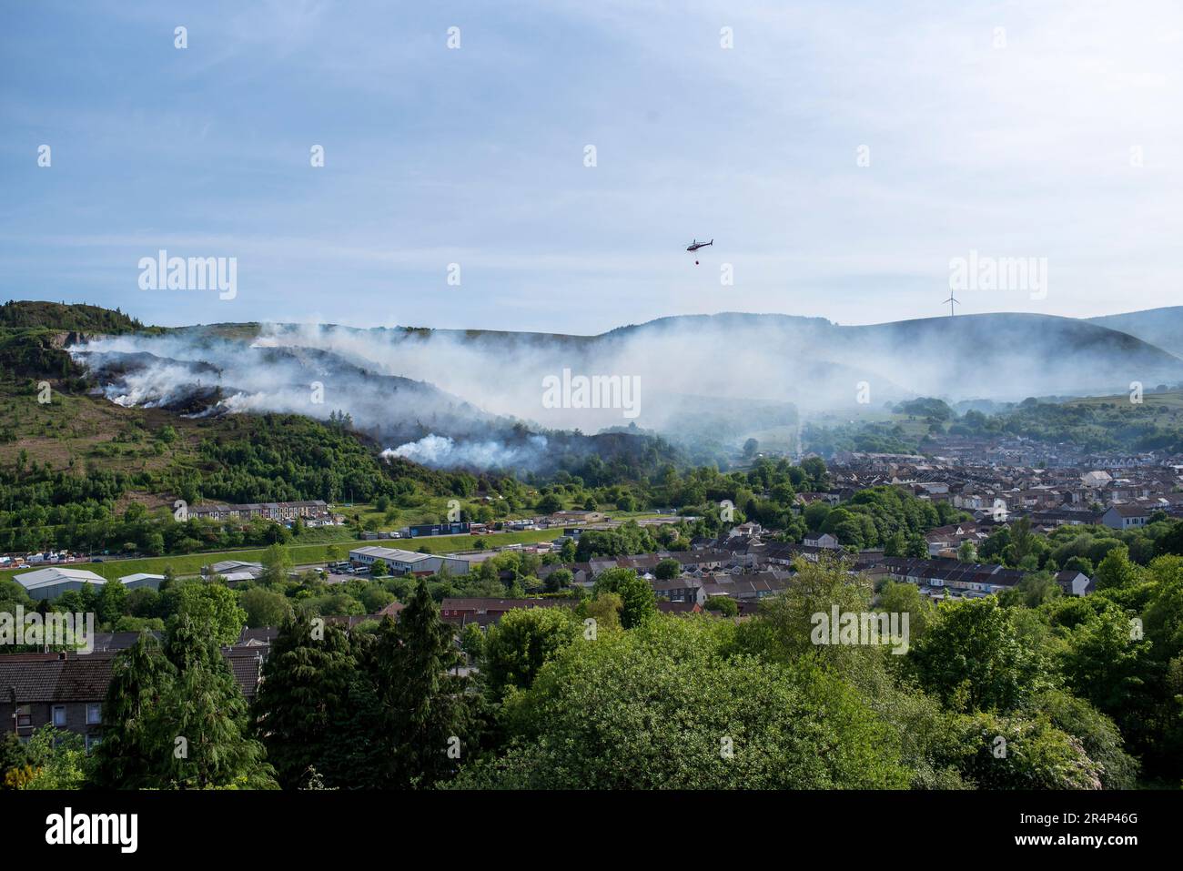 Gelli, Wales, 29 May, 2023: A helicopter with water approaches as Fire ...