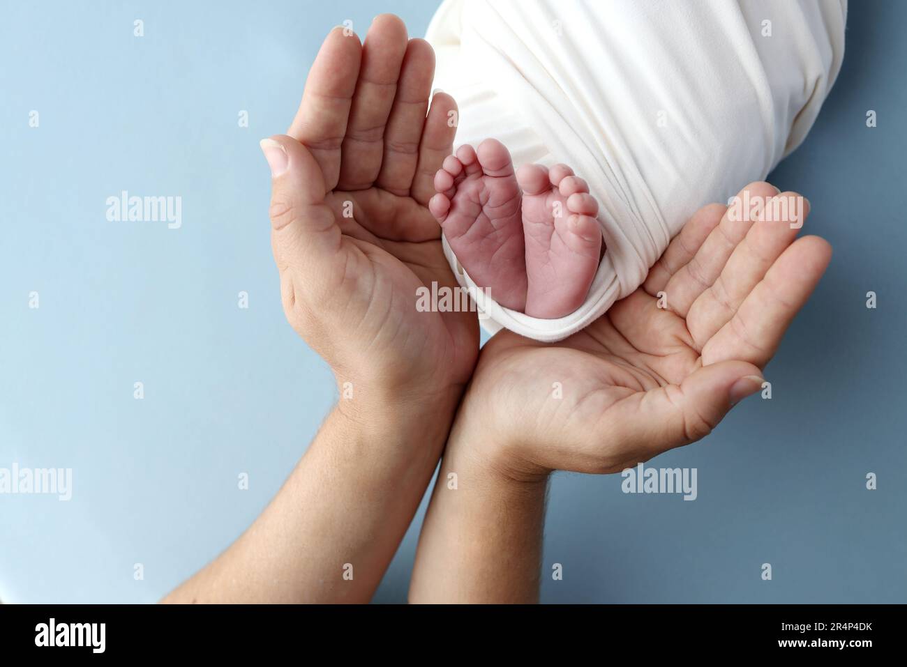Tiny foot of a newborn baby. Soft legs of a newborn in a white blanket ...