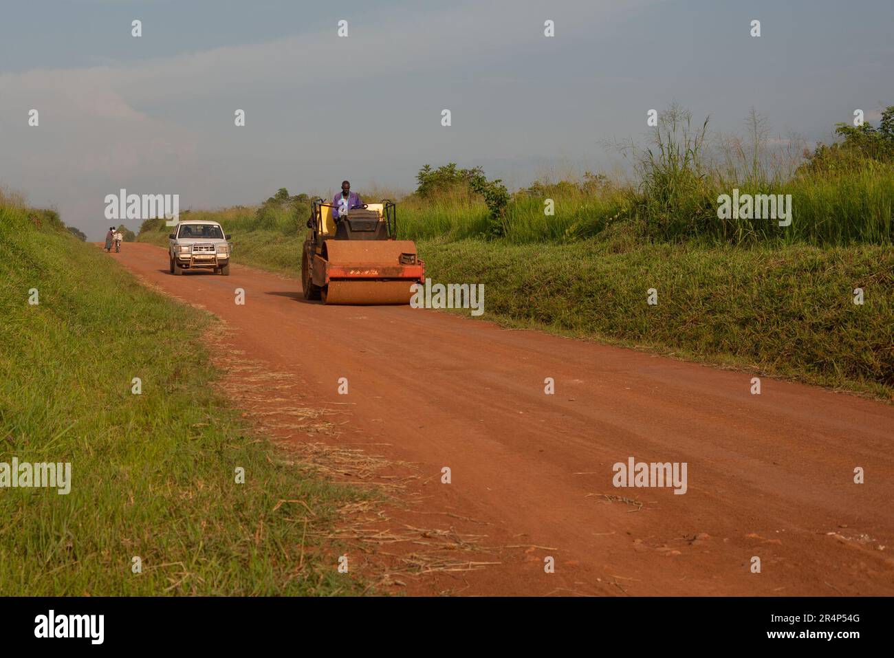 A Road Roller travelling down a dirt road in Northern Uganda Stock ...