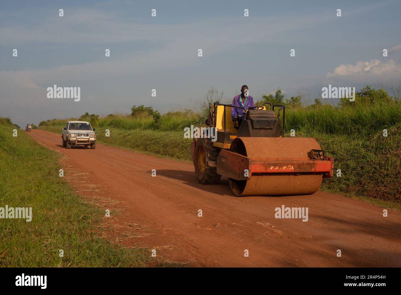 A Road Roller travelling down a dirt road in Northern Uganda Stock ...