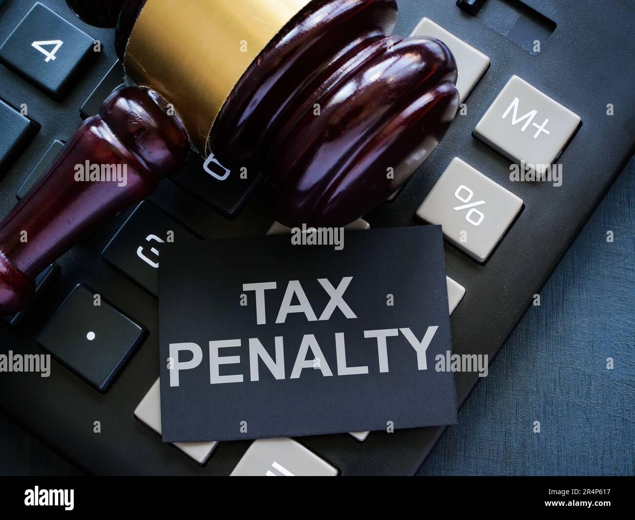Calculator, a gavel and Tax penalty sign Stock Photo - Alamy