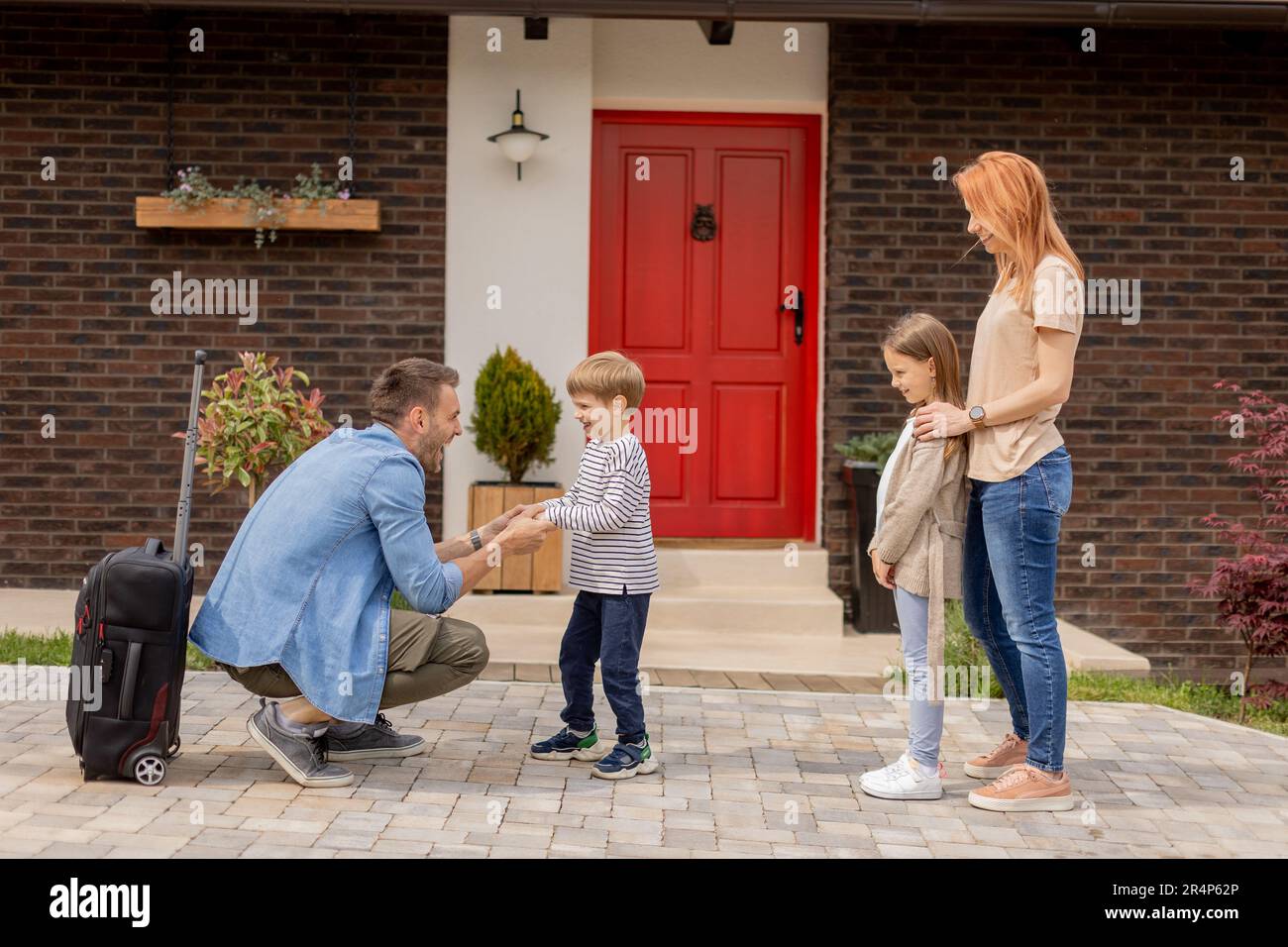 Father came home from the trip and happy son, daughter and wife ...