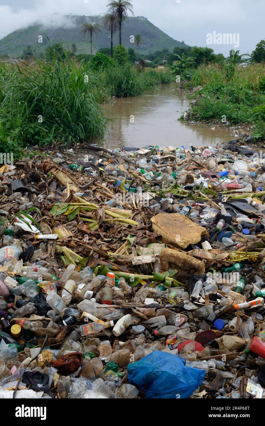 Garbage and discarded mixed plastics floating on a stream in Makeni ...