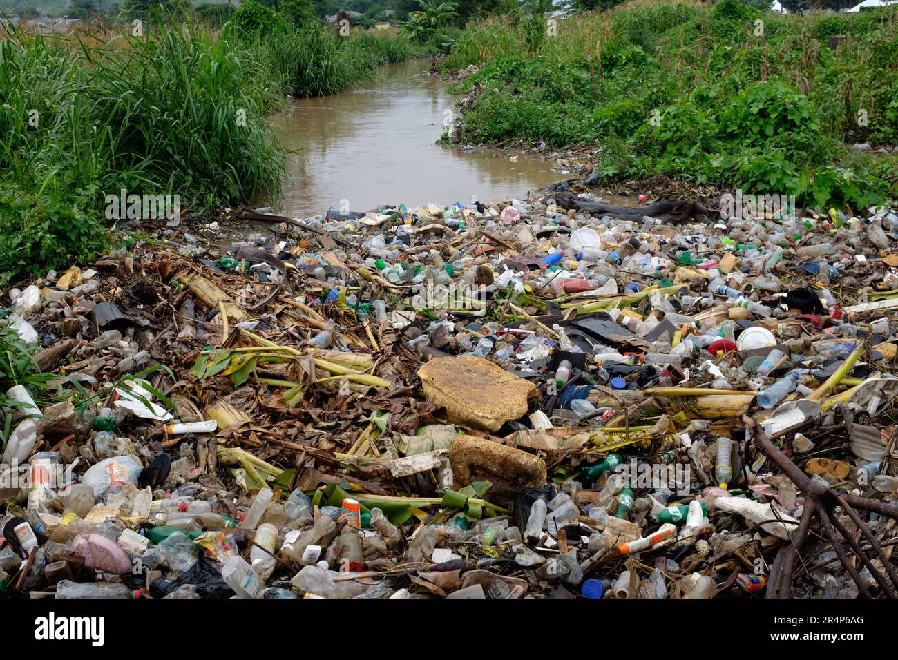 Garbage and discarded mixed plastics floating on a stream in Makeni ...