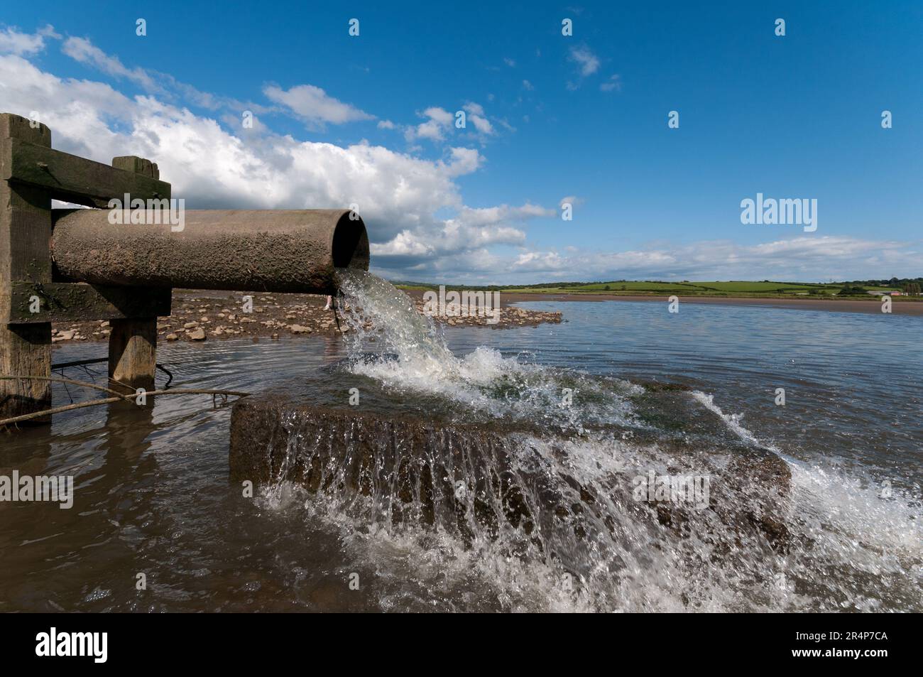 A sewage outfall gushes onto a beach in South Wales, UK Stock Photo - Alamy