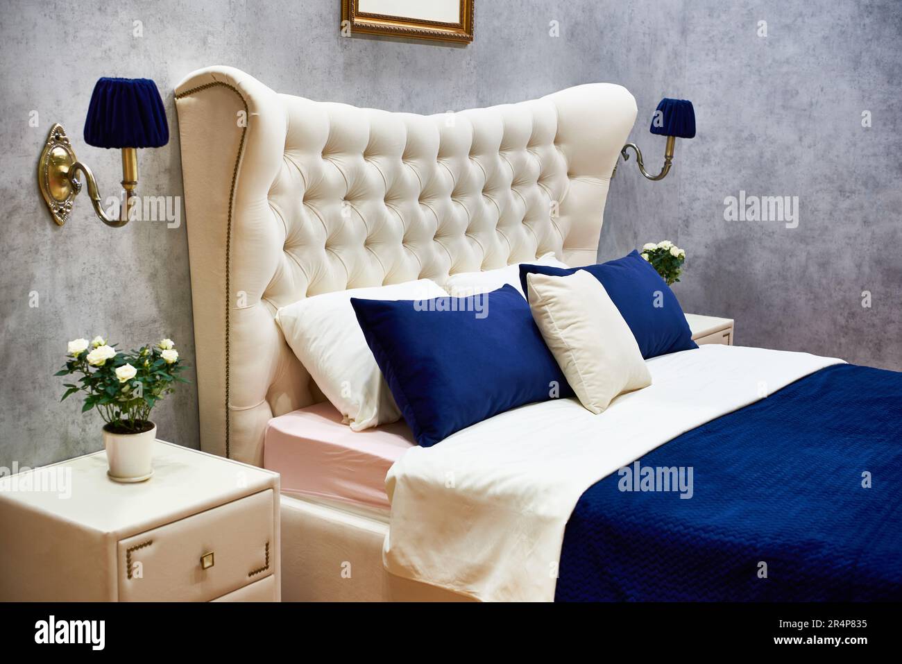 Beautiful bed in the bedroom interior Stock Photo - Alamy