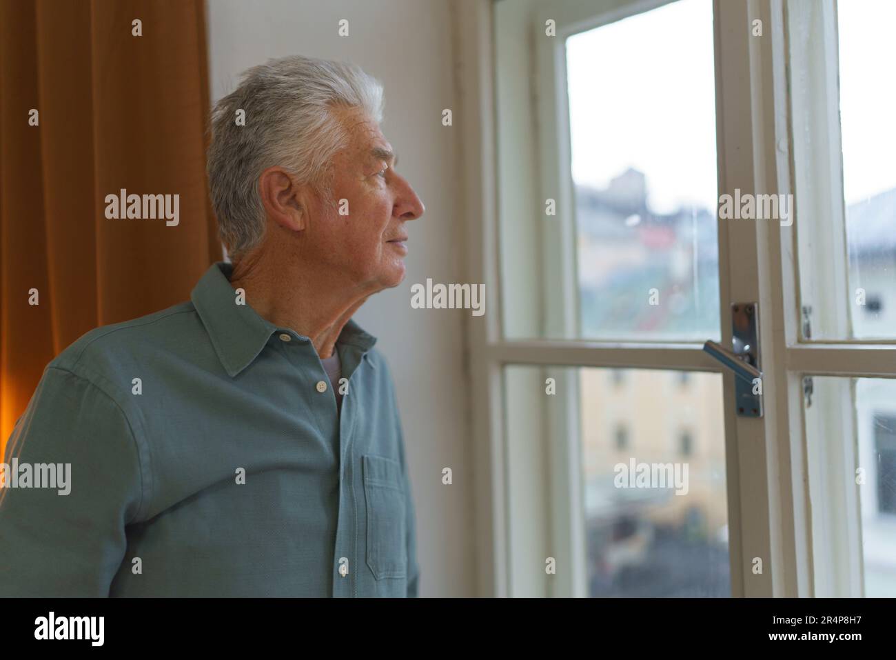 Old man looking out of window sad hi-res stock photography and images ...