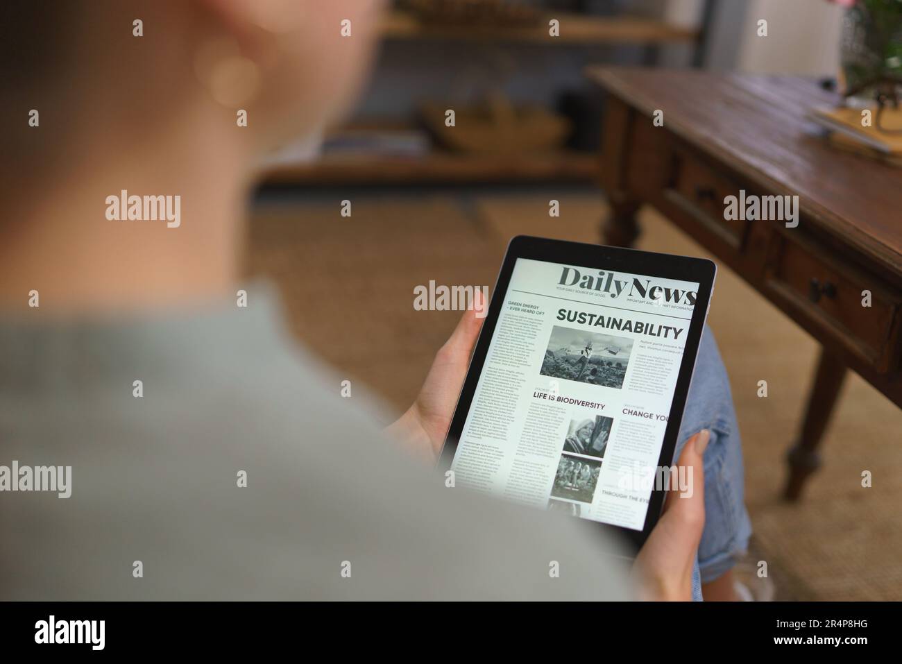 Detail of tablet with news article on screen Stock Photo - Alamy