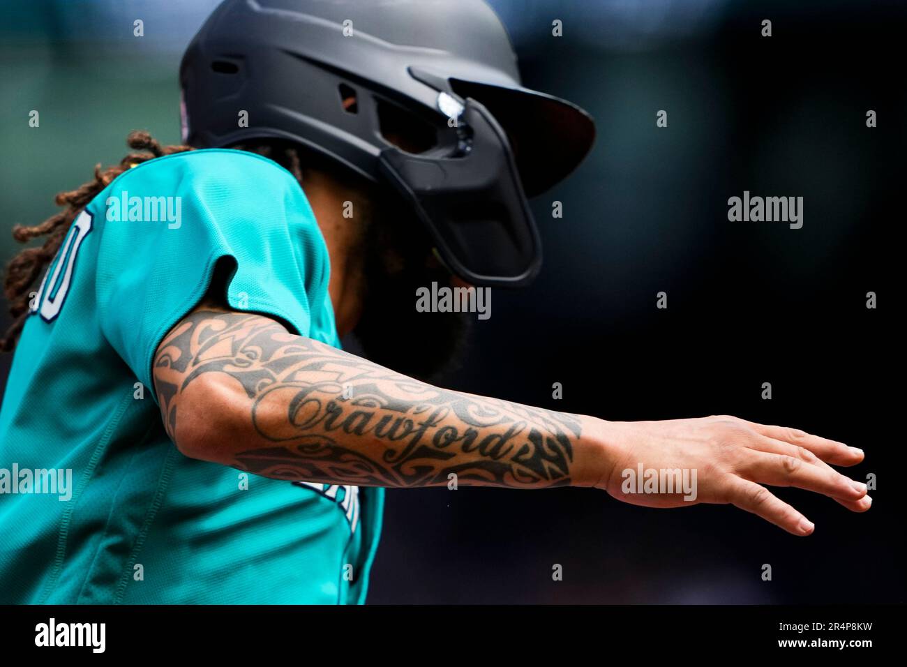 The "Crawford" arm tattoo of Seattle Mariners' J.P. Crawford is visible ...