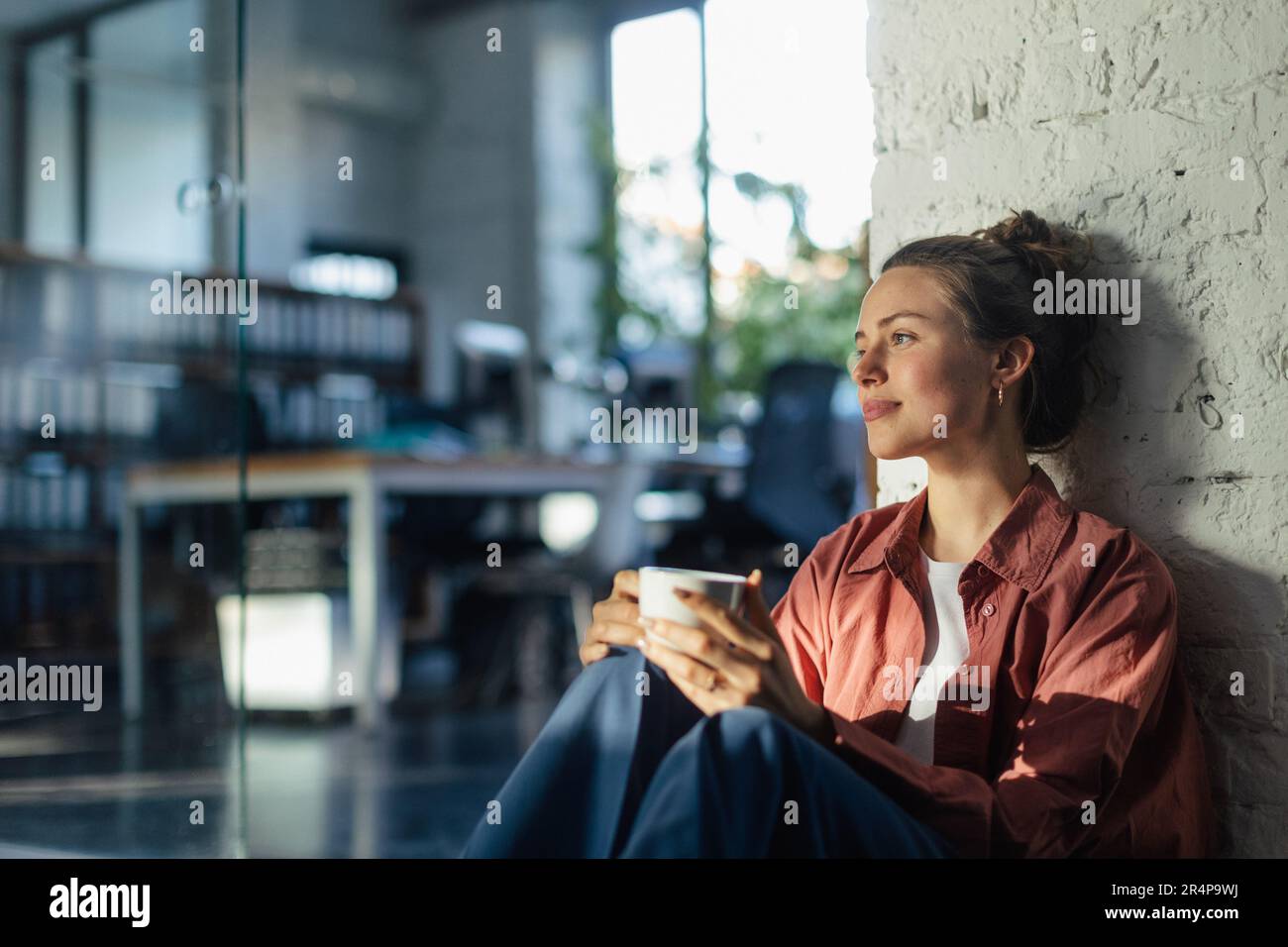Happy female business owner in her own office drinking coffee Stock ...