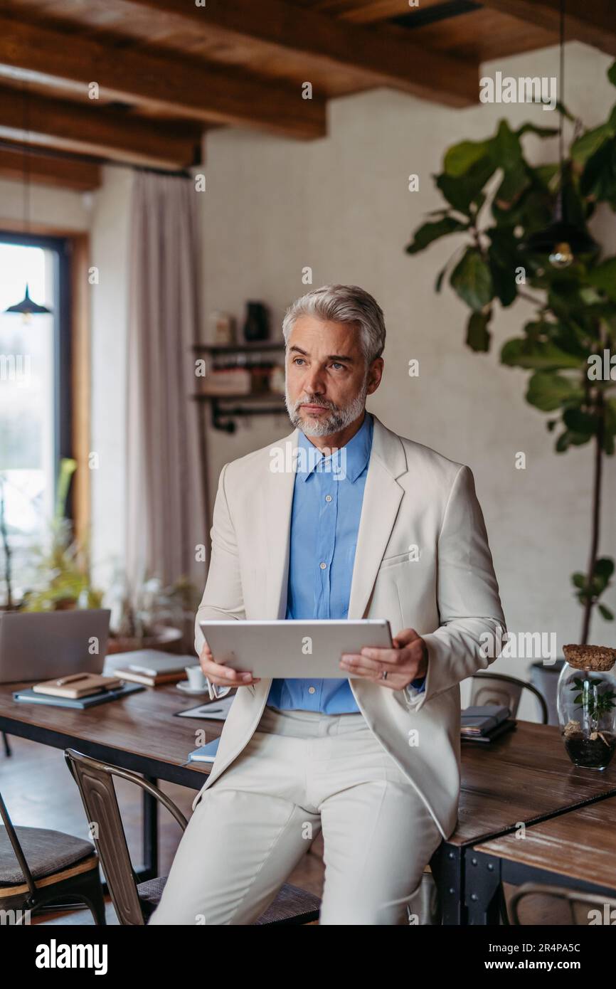 Man leaning against chair looking hi-res stock photography and images ...