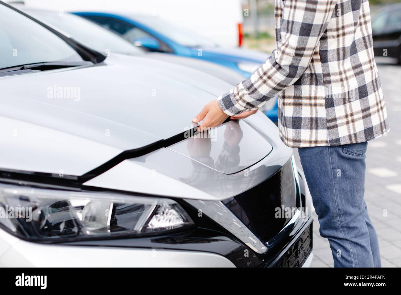Young man checking under the hood of his car to figure out what the problem is Stock Photo - Alamy