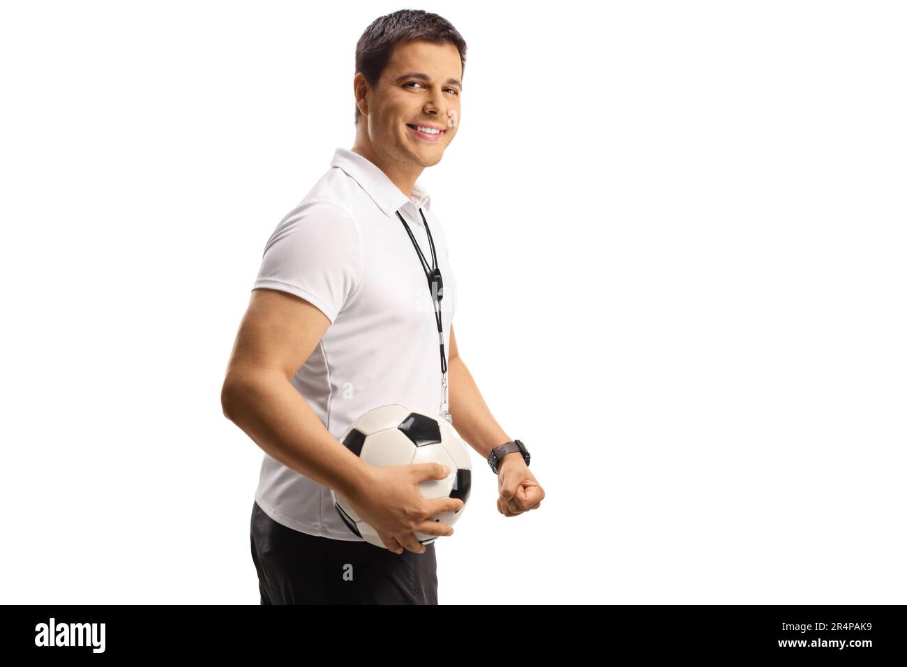 Football coach holding a ball and smiling isolated on white background ...