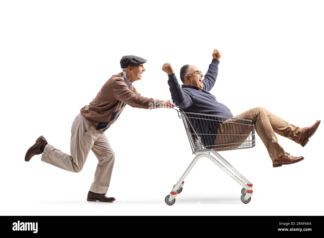 Senior man pushing a friend inside a shopping cart isolated on white ...