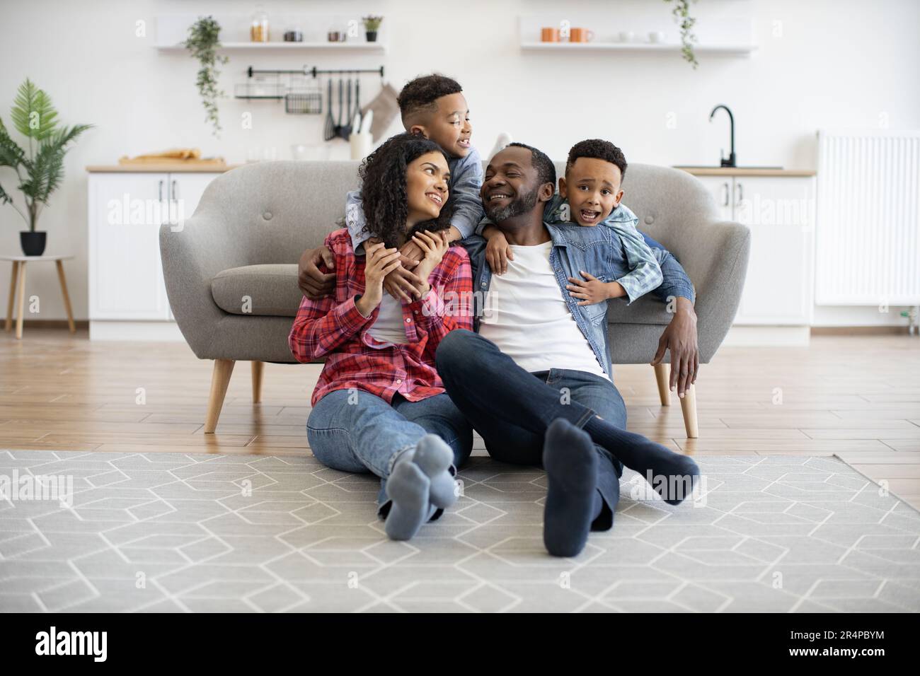 Energetic multiethnic children in jeans clothes talking to relaxed ...