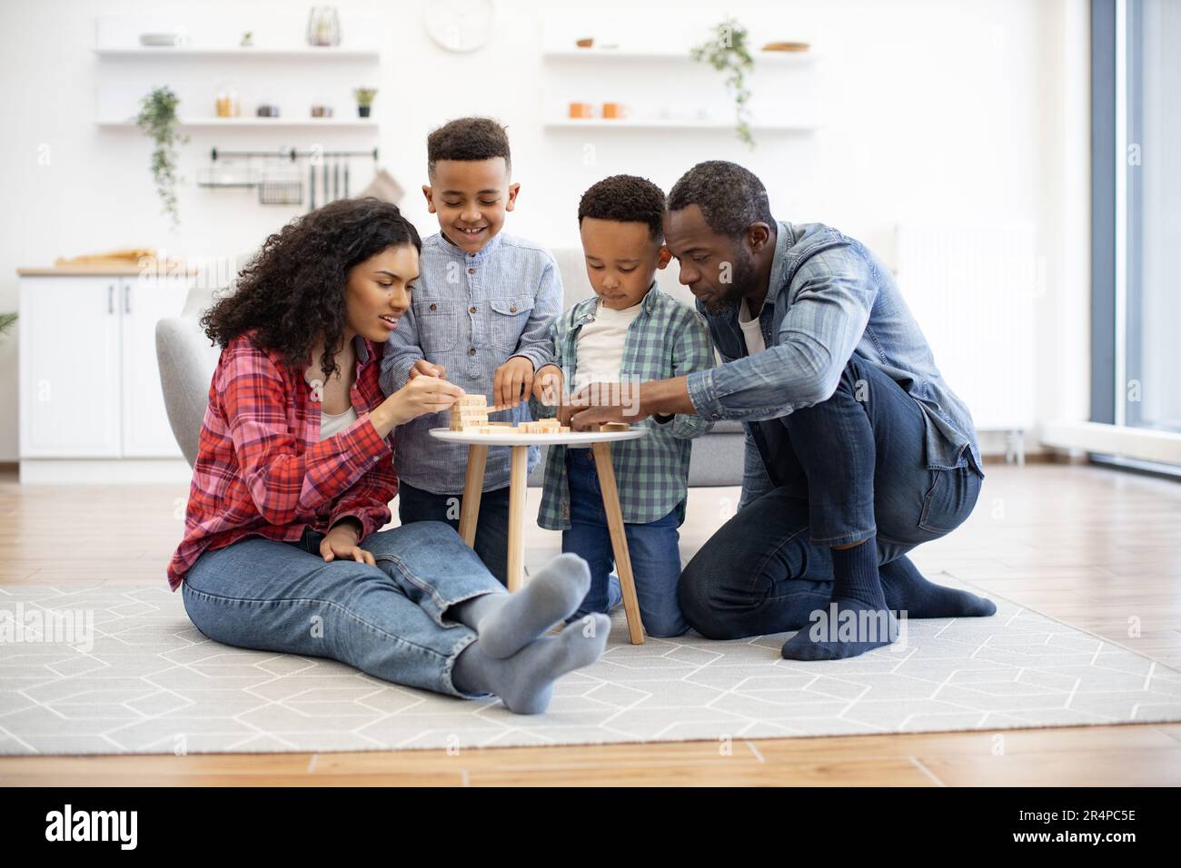 Friendly multiethnic family gathering together around coffee table on ...