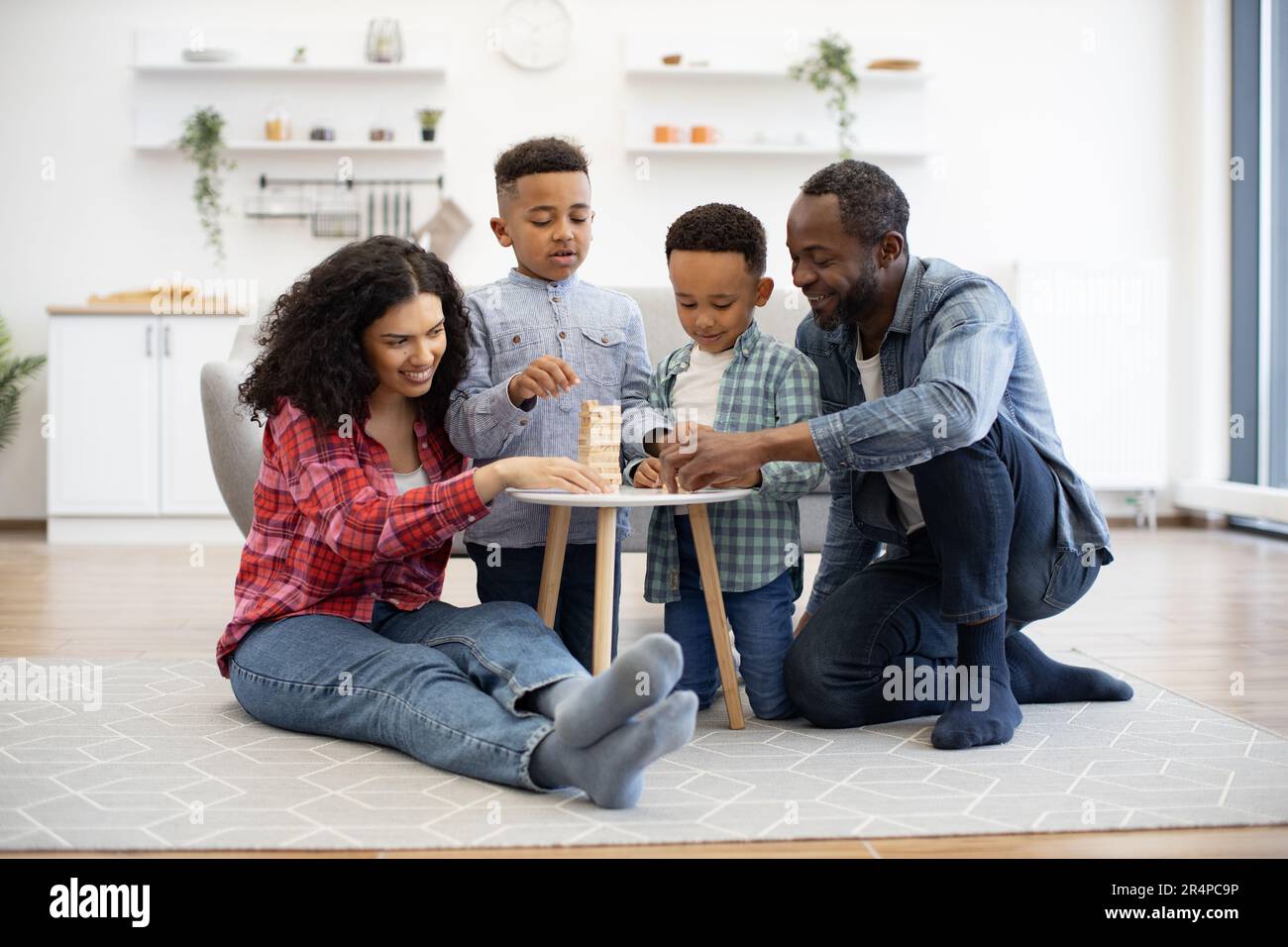 Friendly multiethnic family gathering together around coffee table on ...