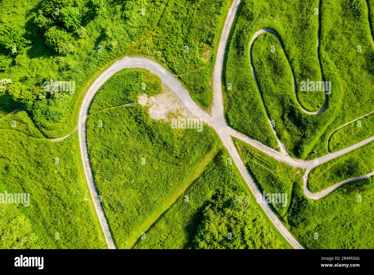 A curvy path through the green meadow aerial photo Stock Photo - Alamy