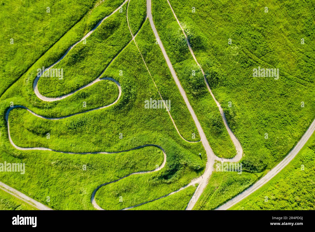 A curvy path through the green meadow aerial photo Stock Photo - Alamy