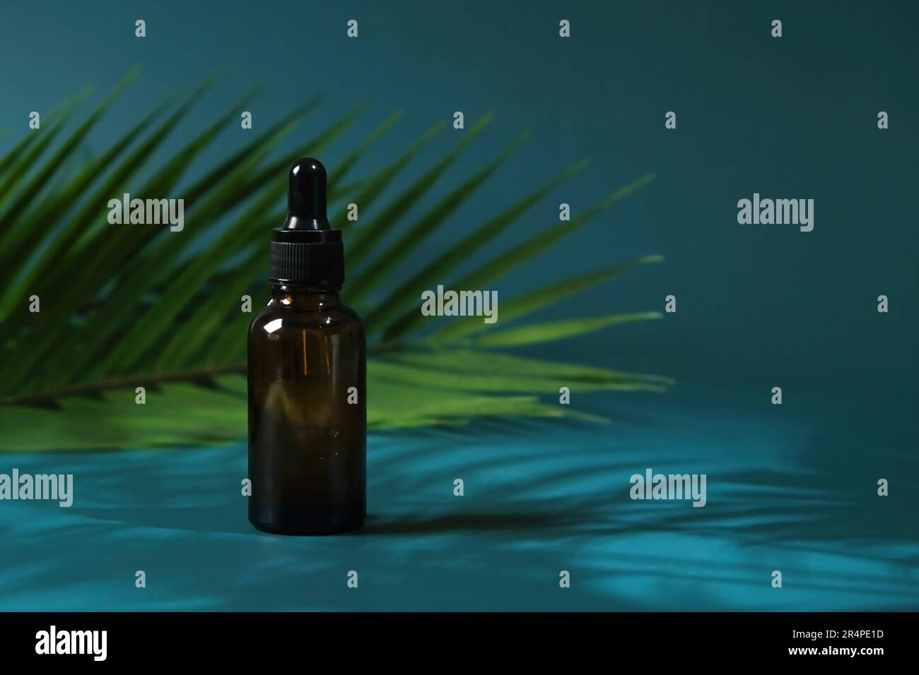 Drop of clear liquid, oil, serum or tincture dripping from pipette in ...