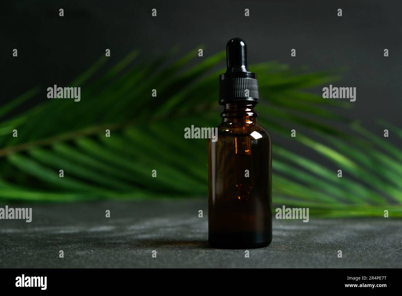Drop of clear liquid, oil, serum or tincture dripping from pipette in ...