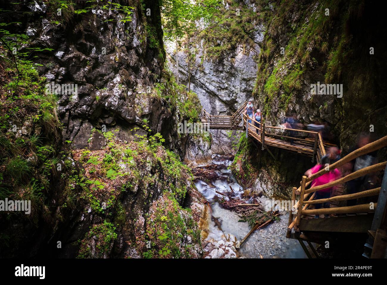View of hikers climbing steps next to white water cascading down the ...