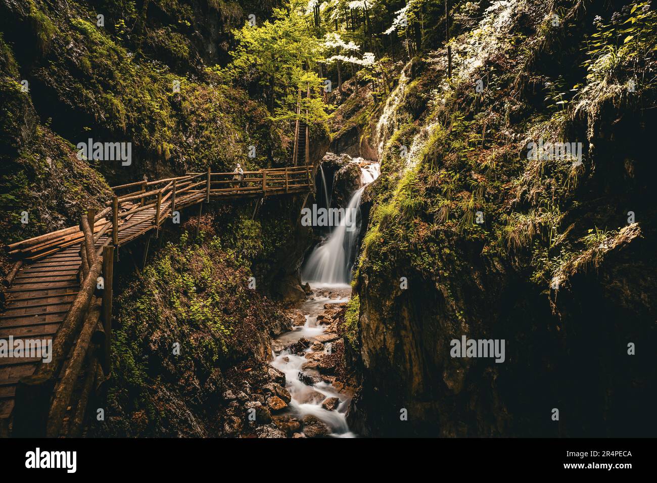 View of a boy watching white water cascading down the rocks at the ...