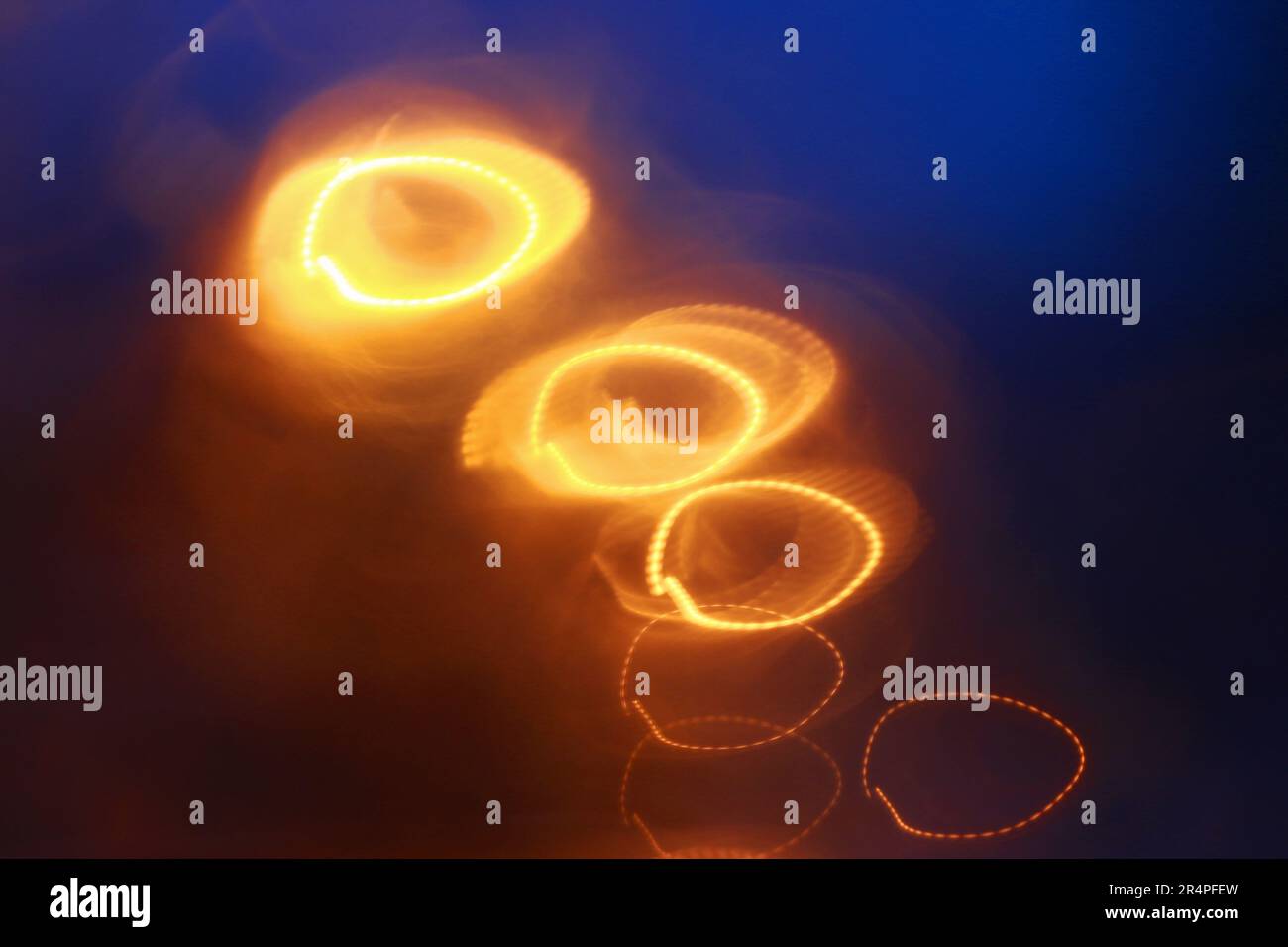 Blured abstract background with warm orange shapes and cold dark blue ...