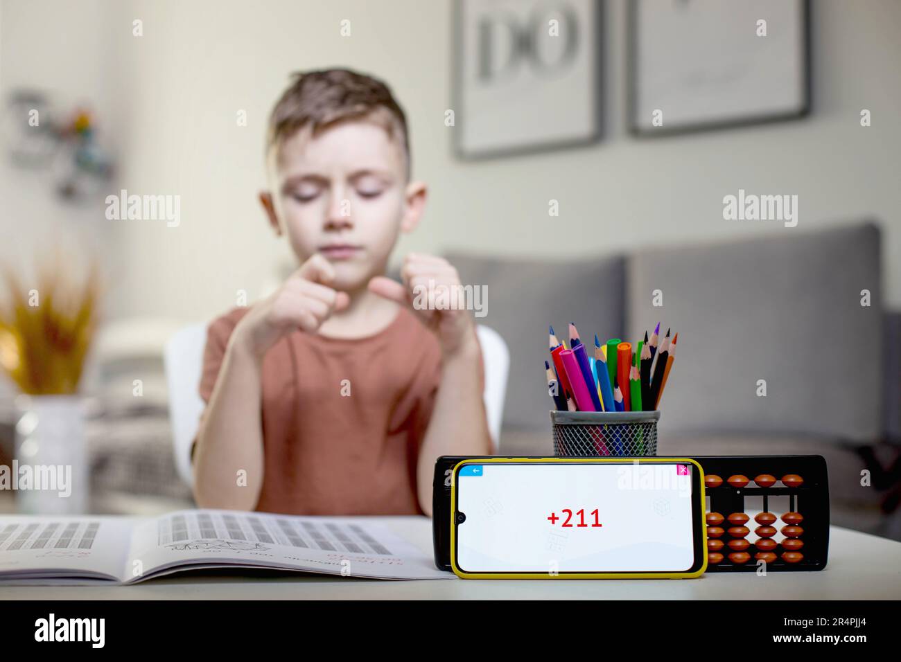 Little boy counting with the help of mental arithmetic. Mathematics in ...