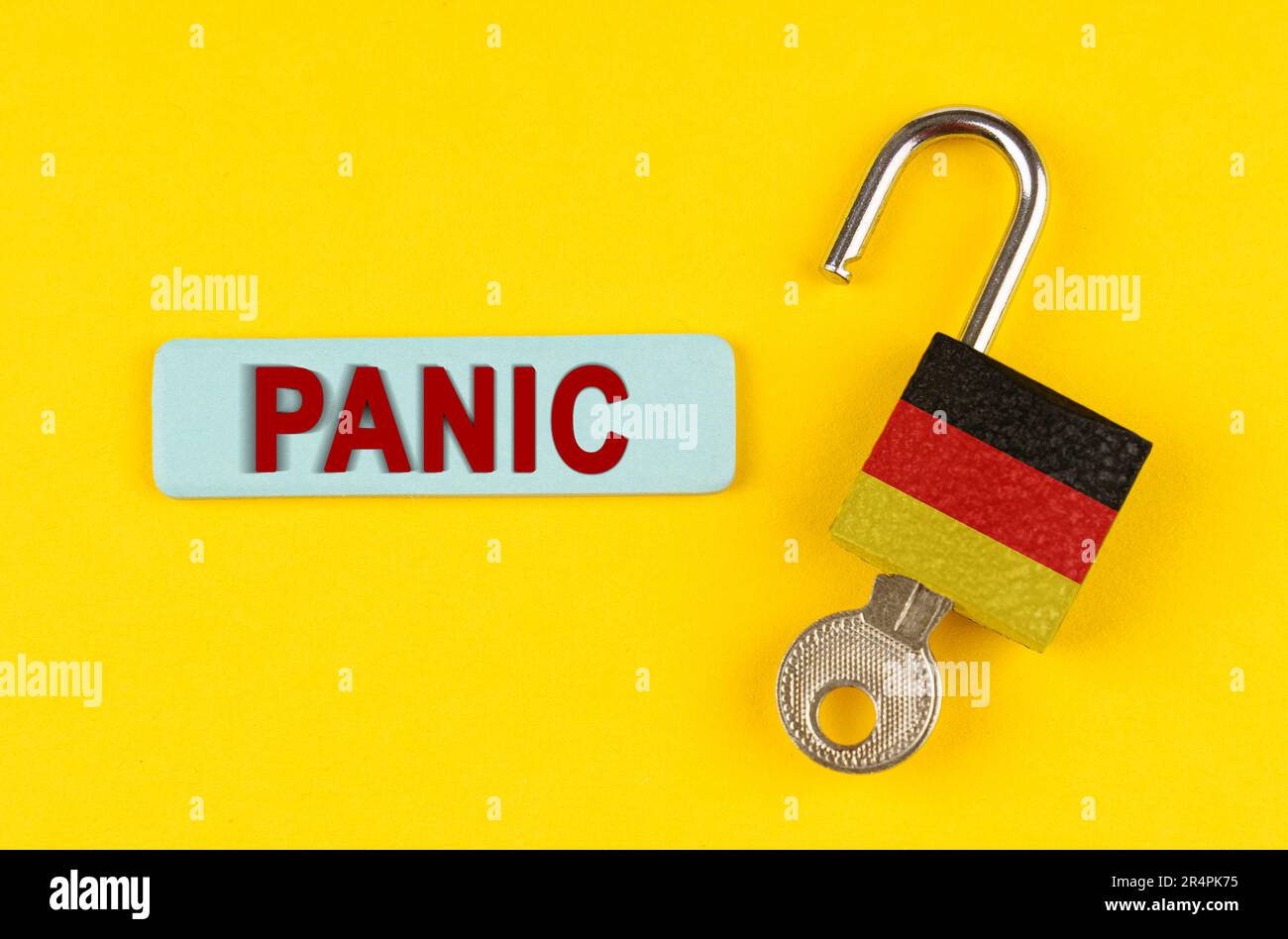 On a yellow surface, an open lock with the image of the flag of Germany ...