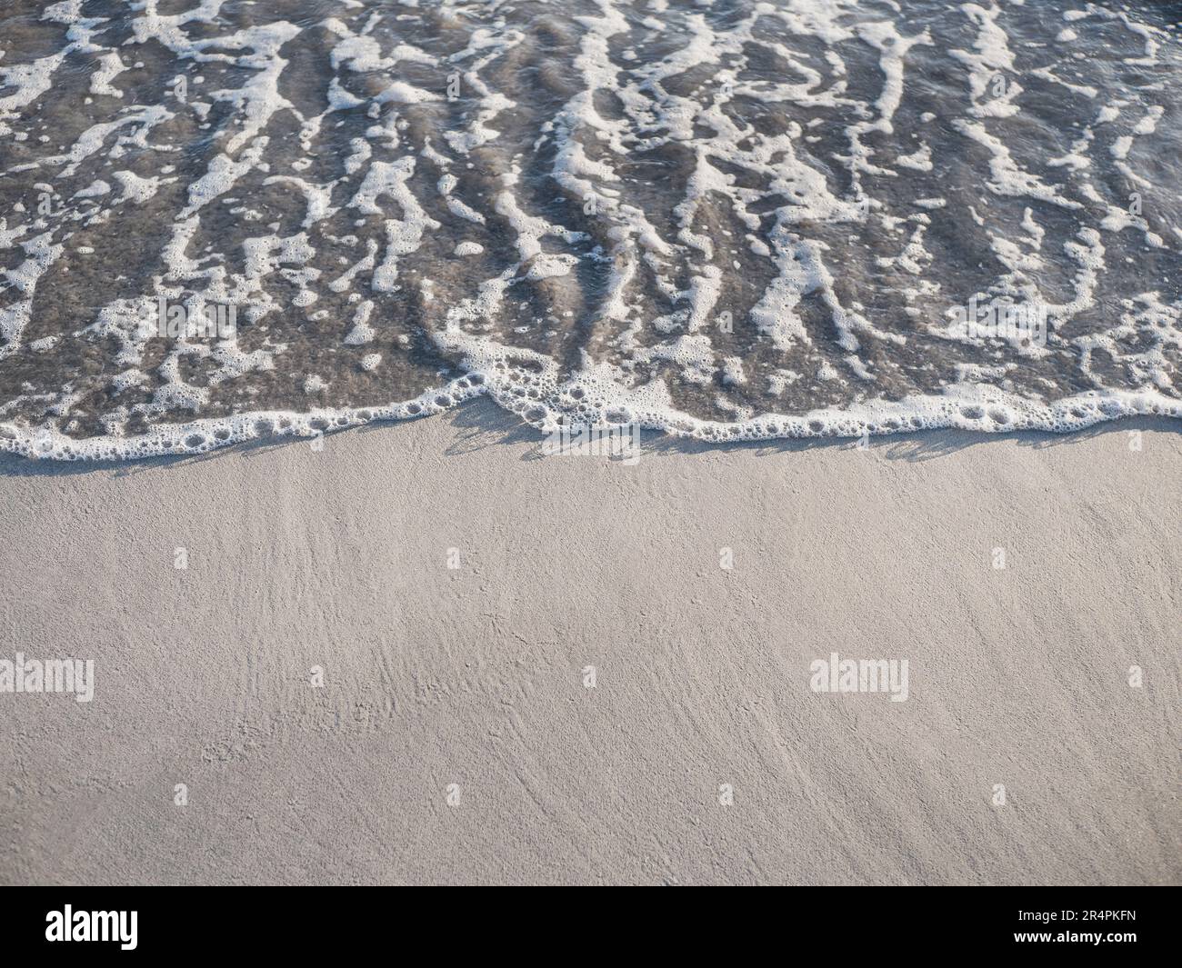 Small wave sweeping the shore close up background with copy space Stock ...