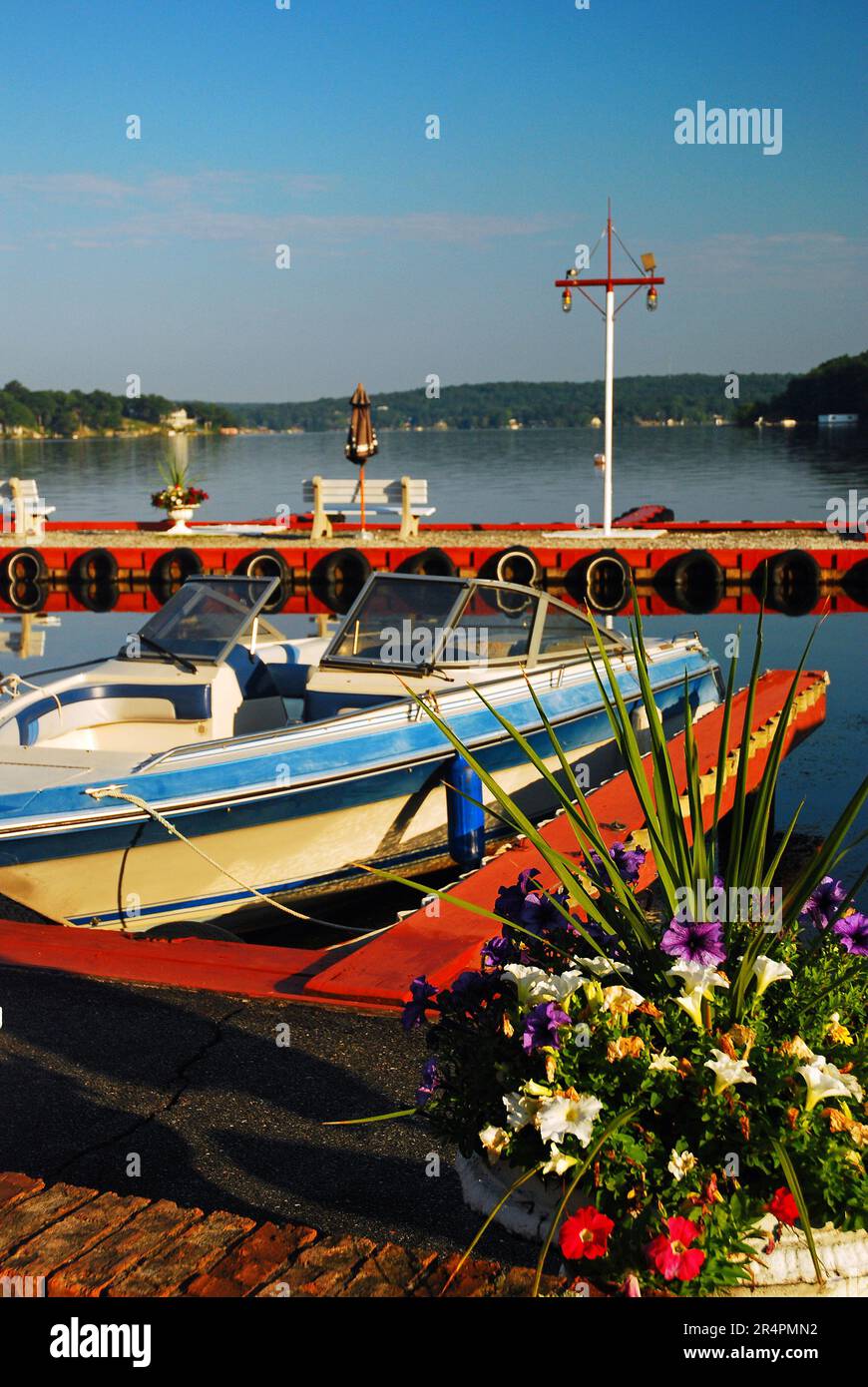 A pleasure craft sits safely in a small harbor on a lakeshore ...