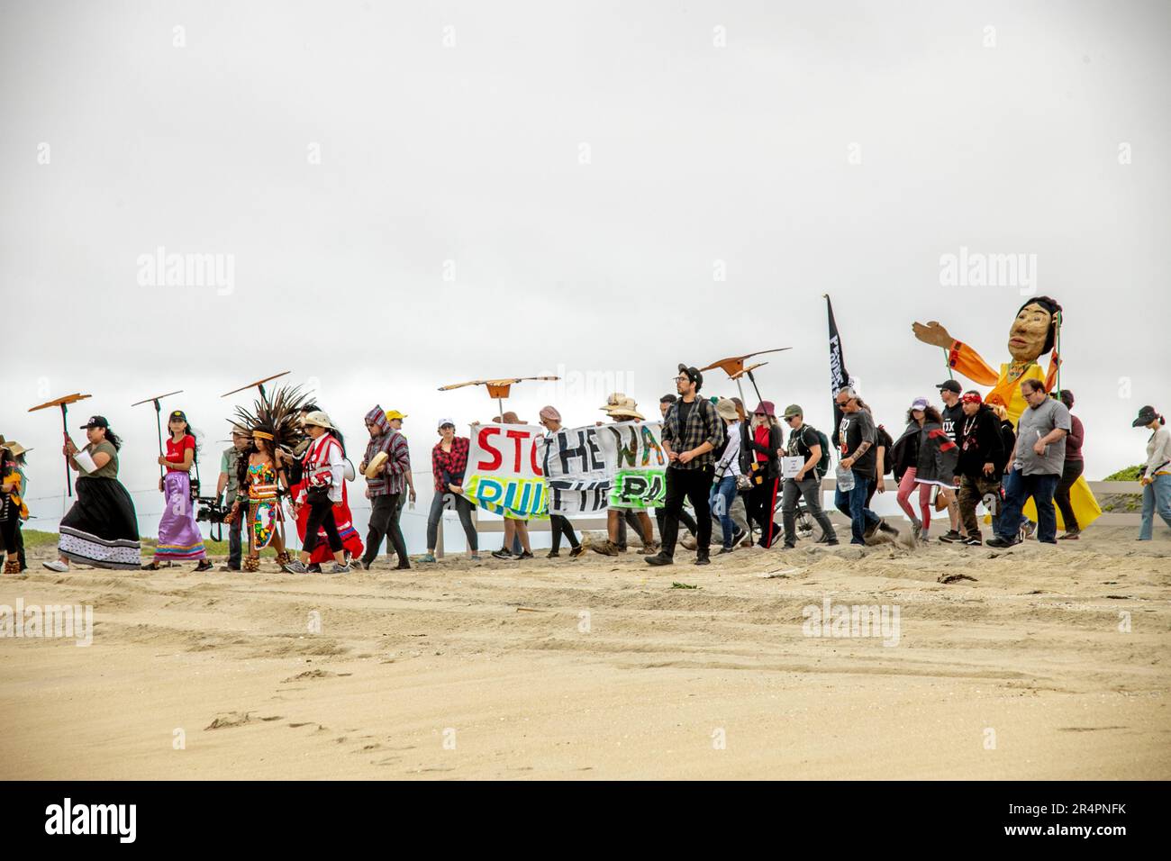 Carrying a figure of a welcoming mother, pro immigration demonstrators ...