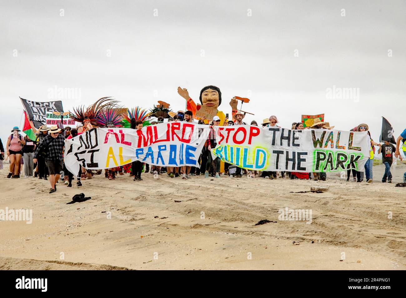 Carrying a figure of a welcoming mother, pro immigration demonstrators ...