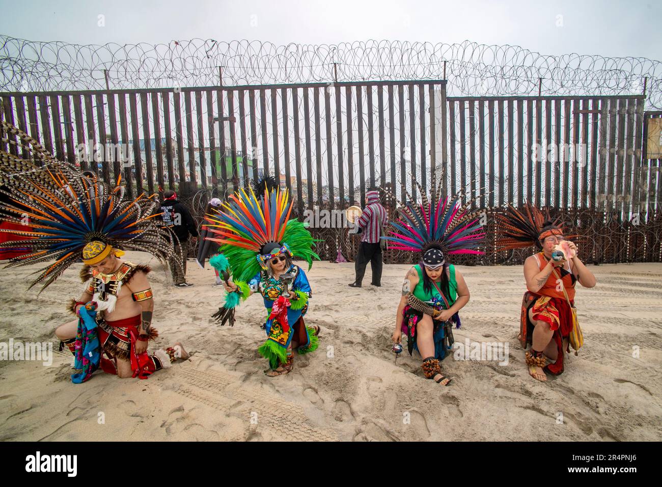 At Border Field Park near San Diego, multiracial demonstrators perform ...
