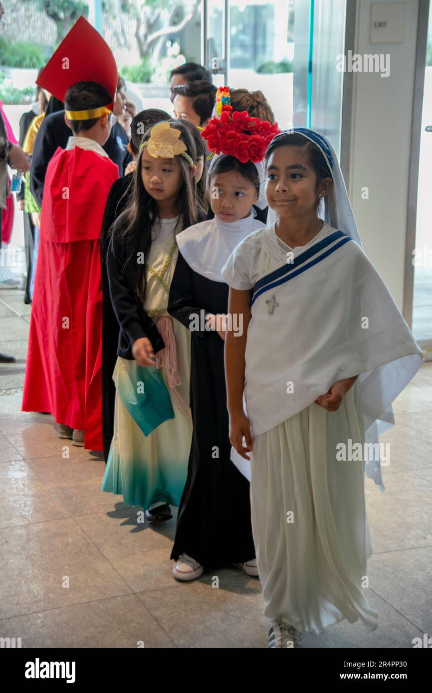Multiethnic elementary school students in religious costumes arrive at ...