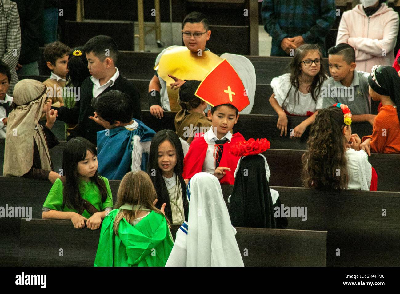 Multiethnic elementary school students in religious costumes arrive at ...