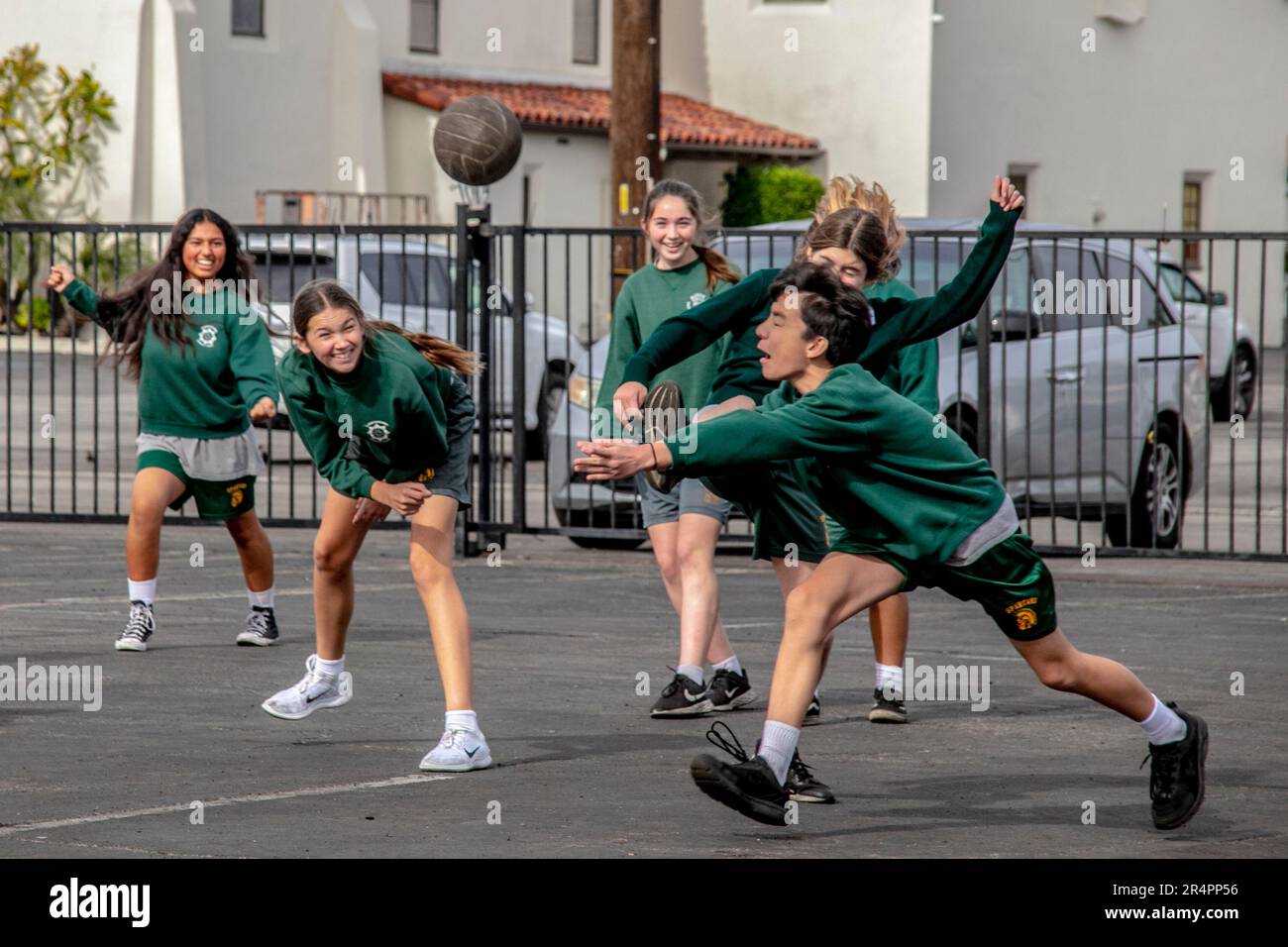 Uniformed multiracial students play lunchtime soccer at a Southern California Catholic middle ...