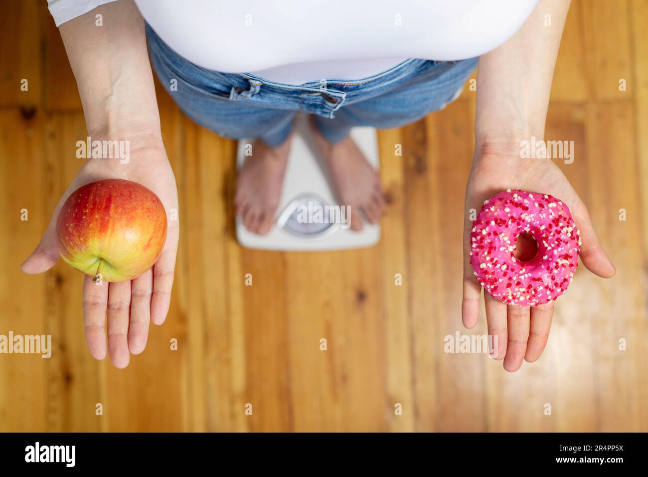 Dieting woman measuring body weighing on scales, hold sweet donut and ...