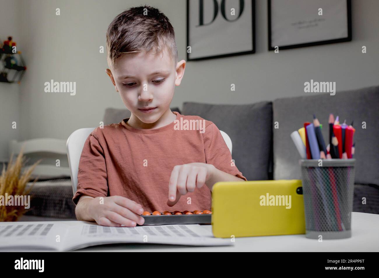 Little preschooler counting large numbers on his fingers using mental ...