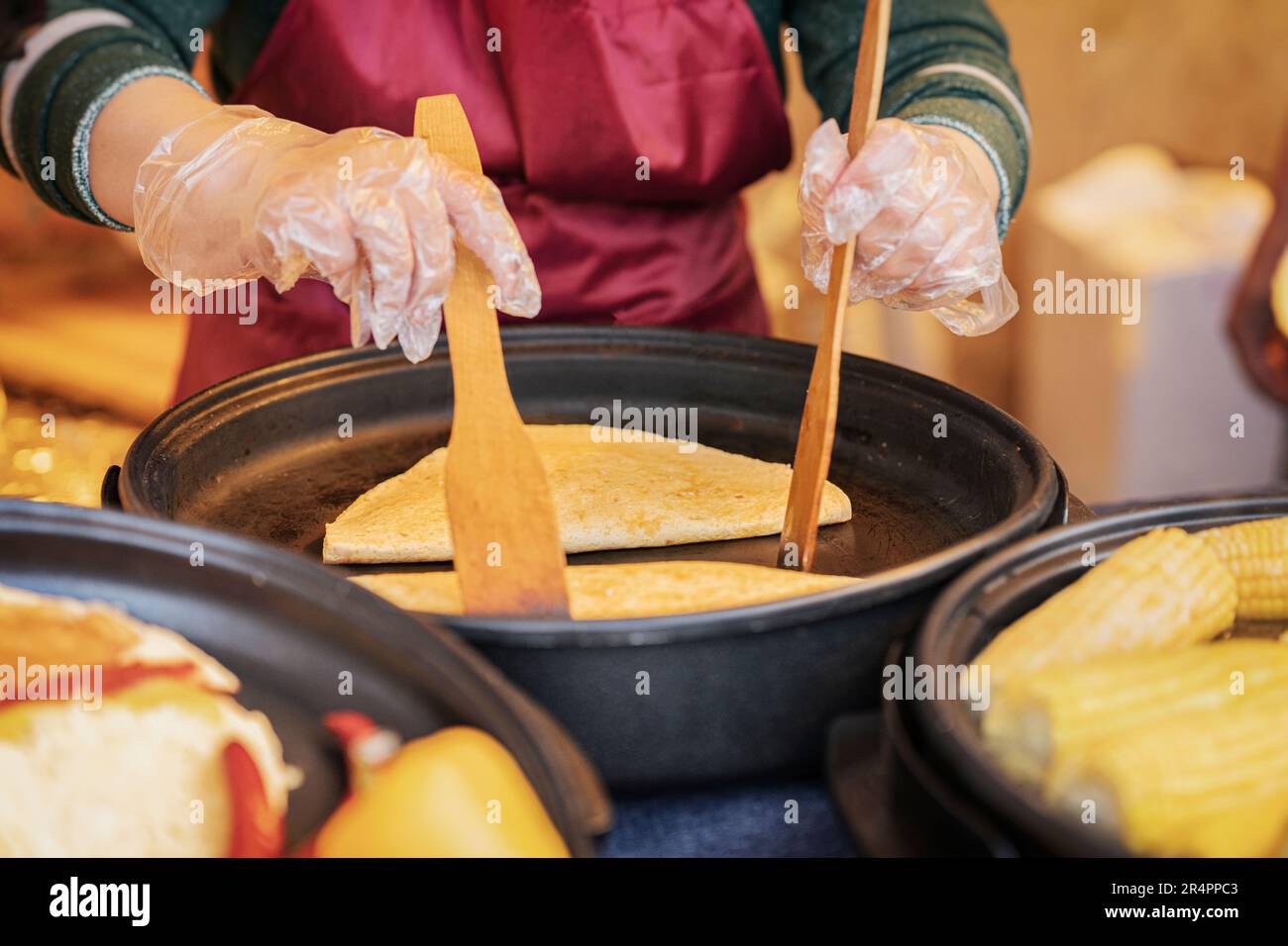 Hands of cook in gloves and apron close-up. Process of preparing ...