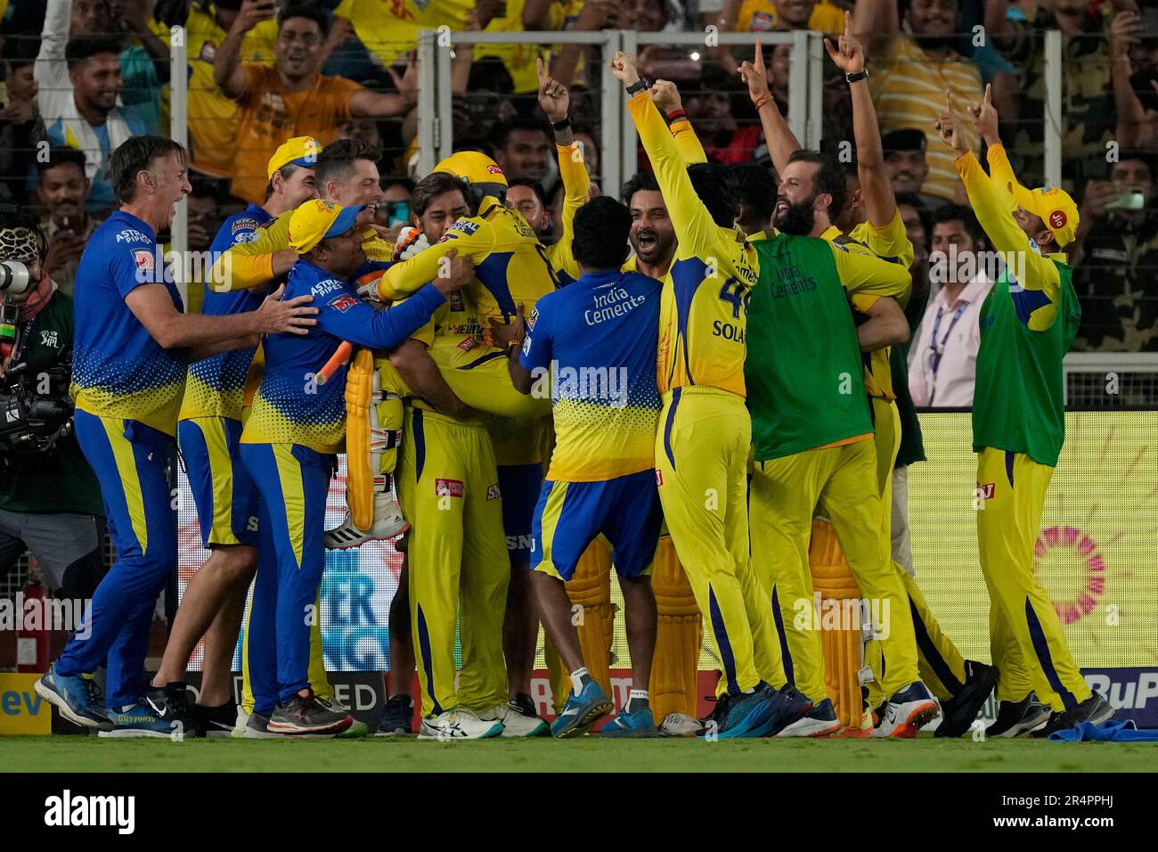 Chennai Super Kings' captain MS Dhoni, center, lifts teammate Ravindra Jadeja to celebrate after ...