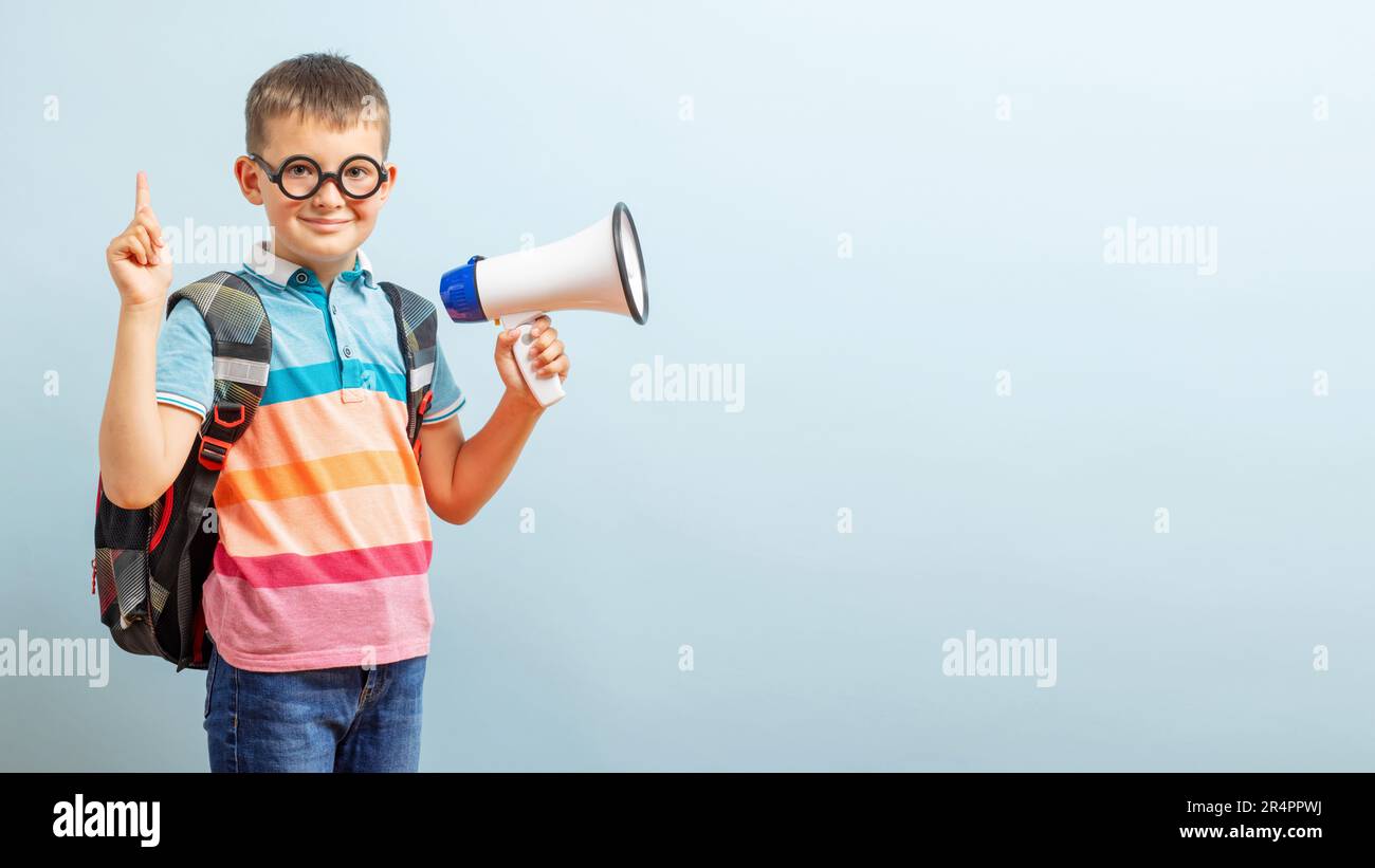 Little schoolboy with megaphone on blue background. Boy with megaphone ...