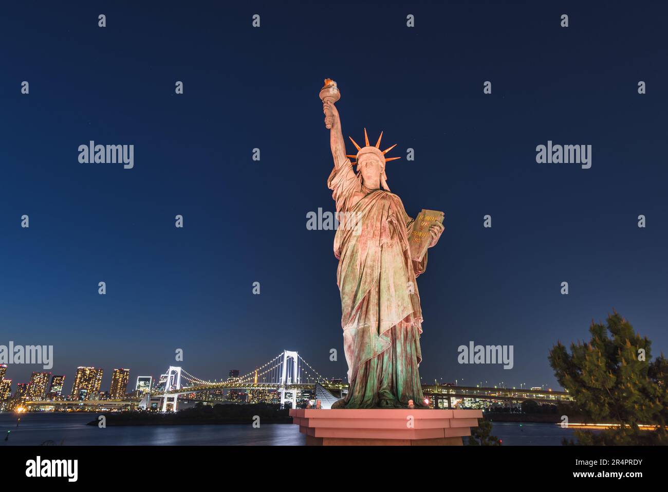 Statue of Liberty at the Odaiba Seaside Park with the Rainbow Bridge in ...